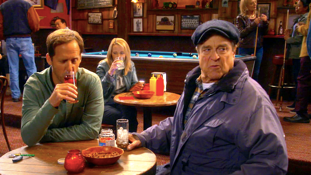 The Conners’ Dan & Neville Fight Risks Ruining Jackie’s Season 5 Twist
